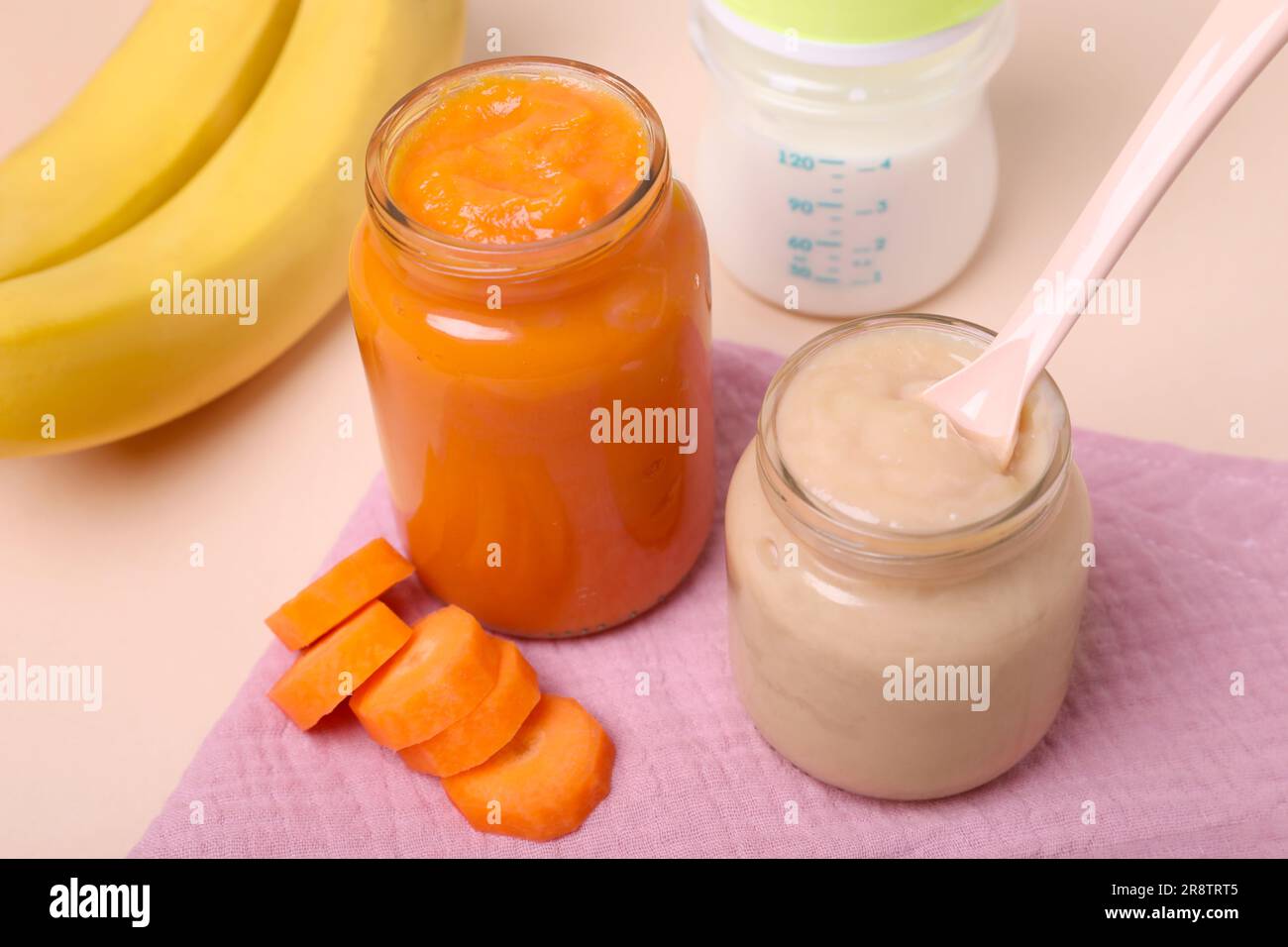 Healthy baby food, spoon and ingredients on pale pink background Stock ...