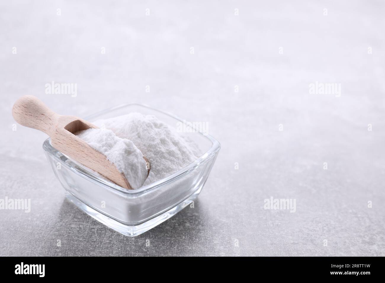 Bowl of sweet fructose powder on light grey table. Space for text Stock ...