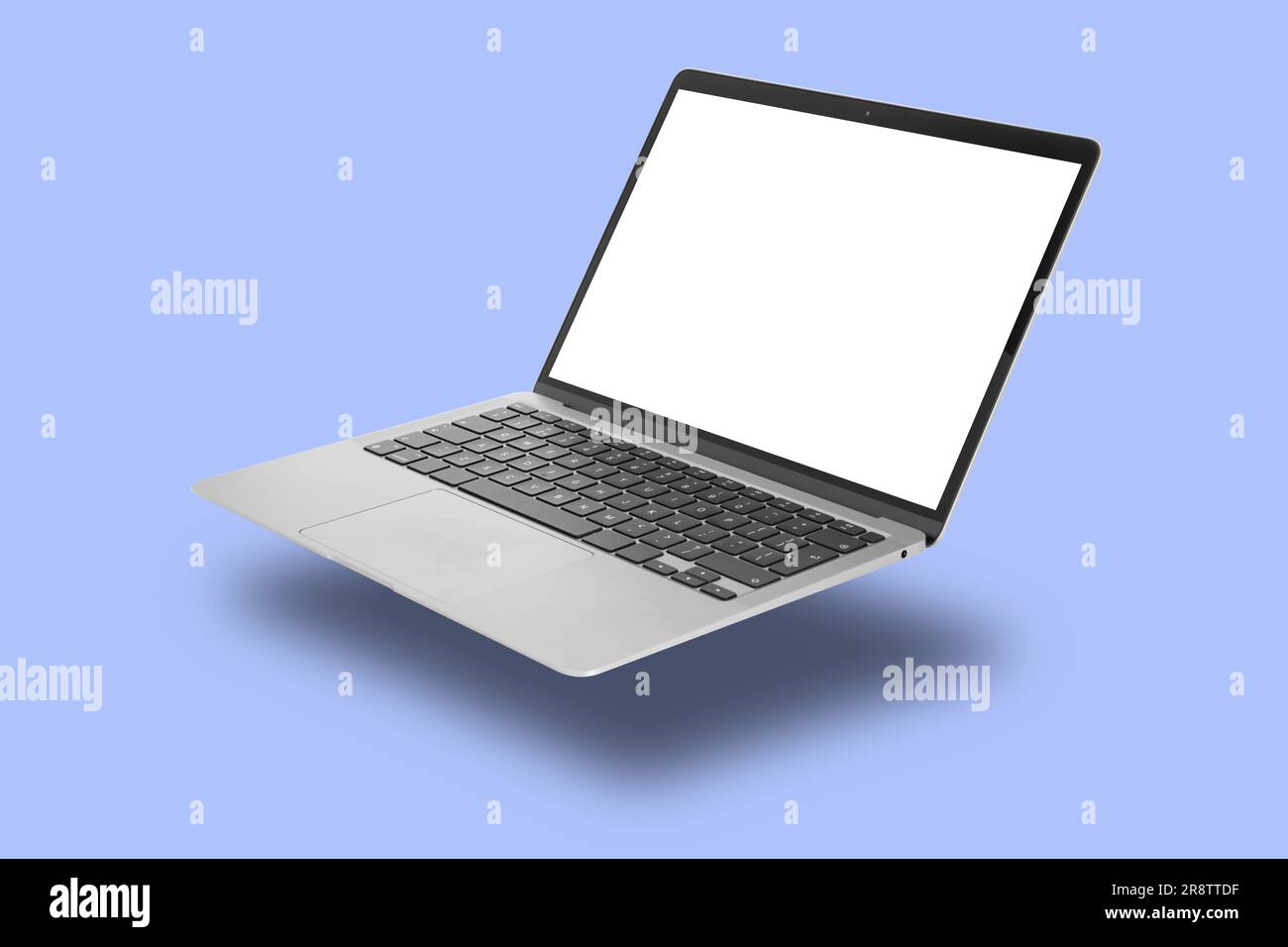 Modern laptop flying on light slate blue background Stock Photo - Alamy