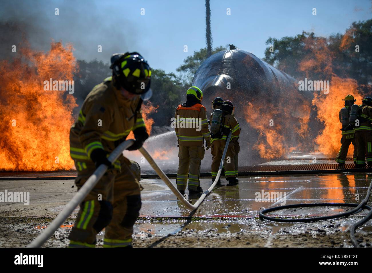 A U.S. Air Force Firefighter with the 424th Air Base Squadron pulls the ...