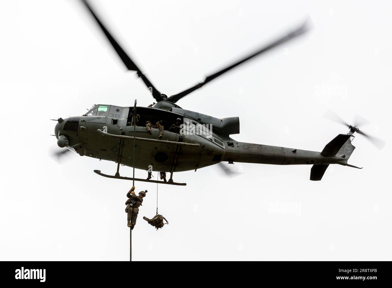 A U.S. Marine with 3rd Reconnaissance Battalion fast ropes from a UH-1Y ...