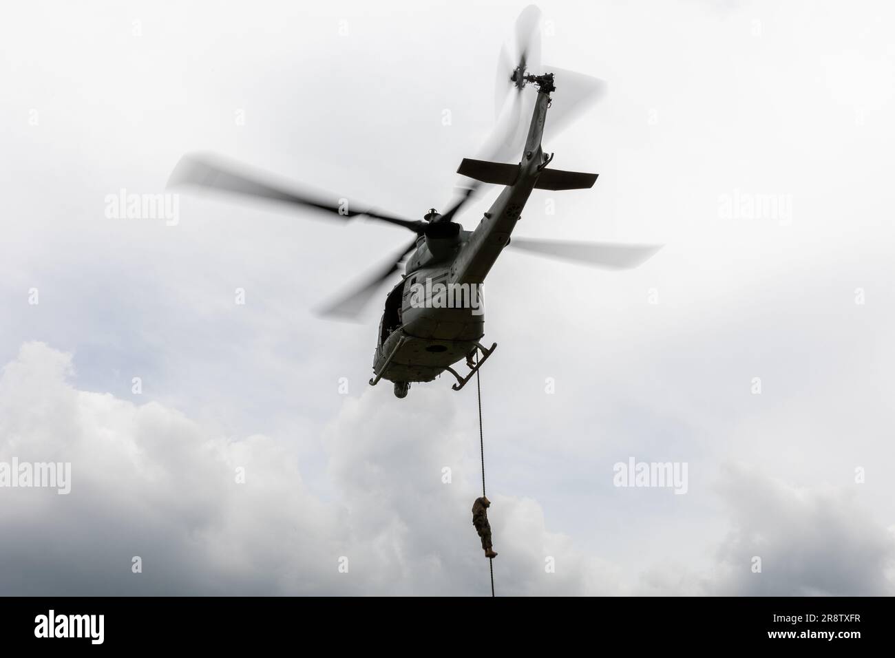 A U.S. Marine with 3rd Reconnaissance Battalion fast ropes from a UH-1Y ...