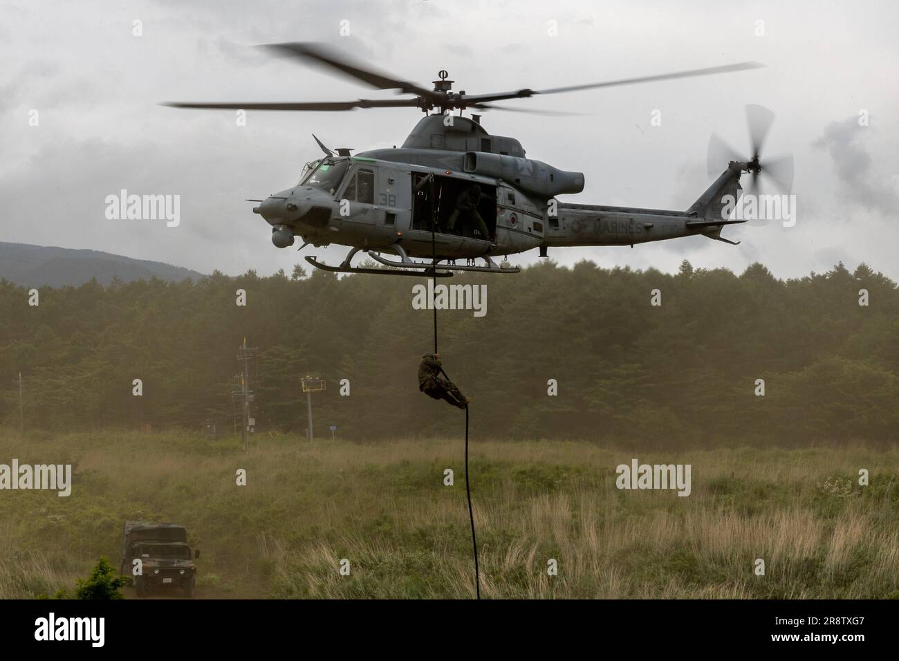 A U.S. Marine with 3rd Reconnaissance Battalion fast ropes from a UH-1Y ...
