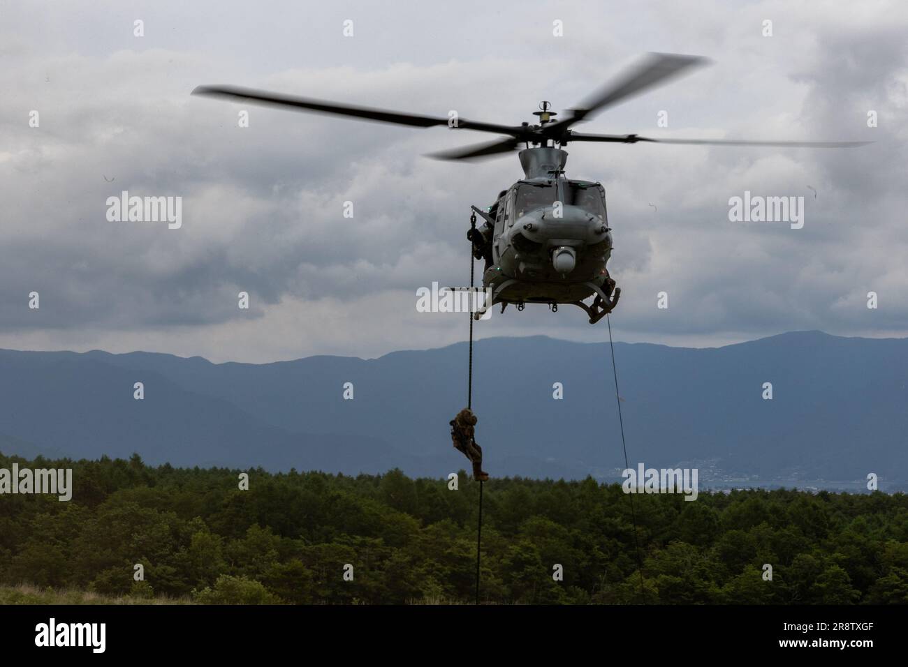 A U.S. Marine with 3rd Reconnaissance Battalion fast ropes from a UH-1Y ...
