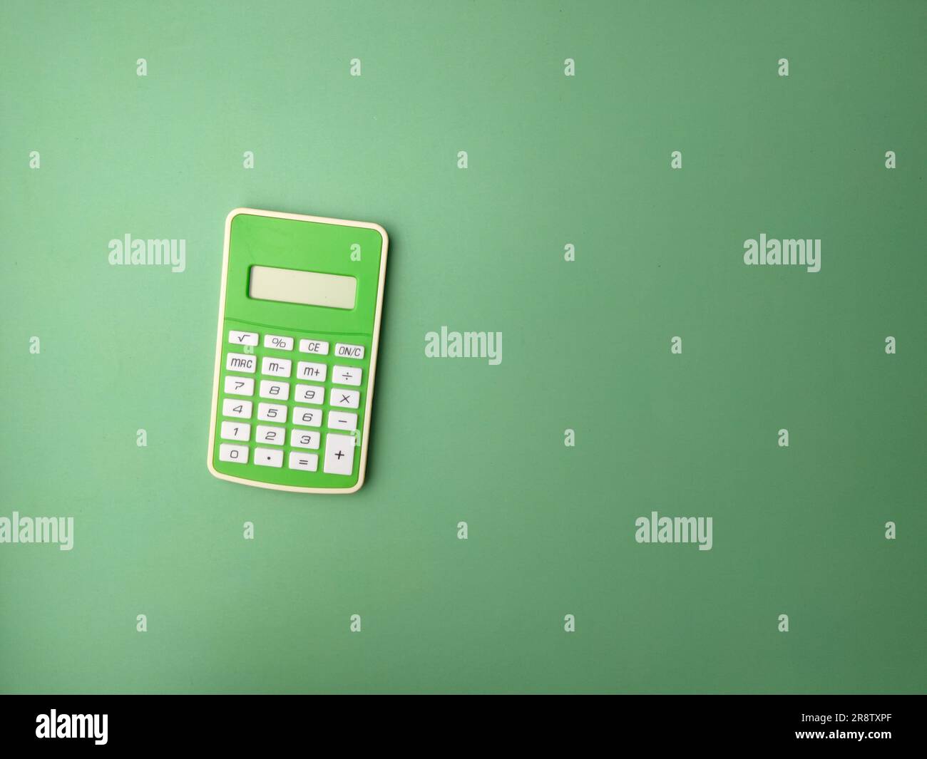 Top view green calculator on a green background with copy space ...