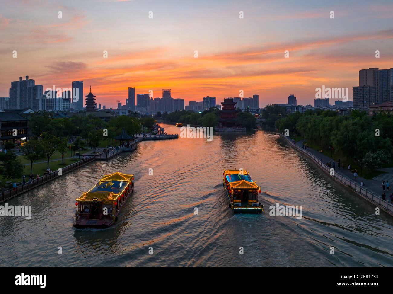 HUAI'AN, CHINA - JUNE 22, 2023 - Tourists take a boat ride, shop and ...
