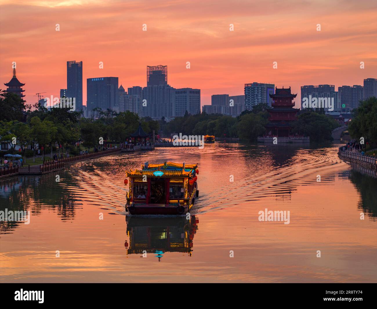 HUAI'AN, CHINA - JUNE 22, 2023 - Tourists take a boat ride, shop and ...