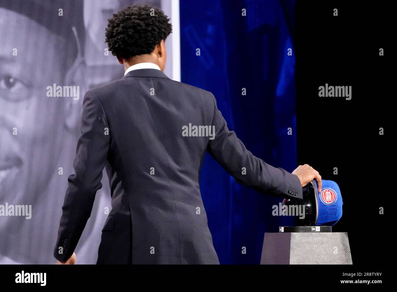 Ausar Thompson picks up a Detroit Pistons cap after being selected ...