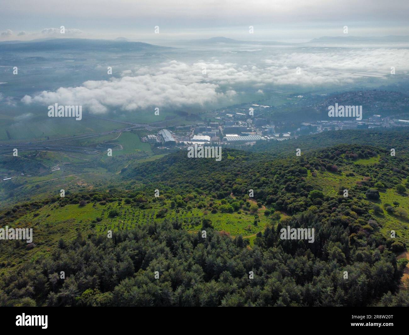 An aerial view of a small village with lush green trees growing on ...