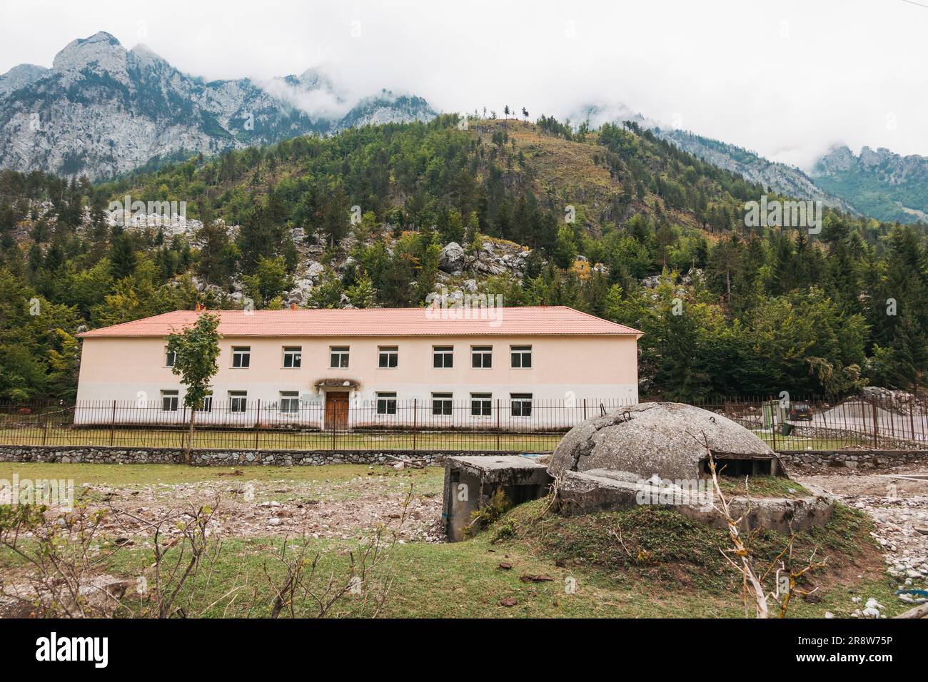 a communist era concrete bunker in front of an old school building in ...