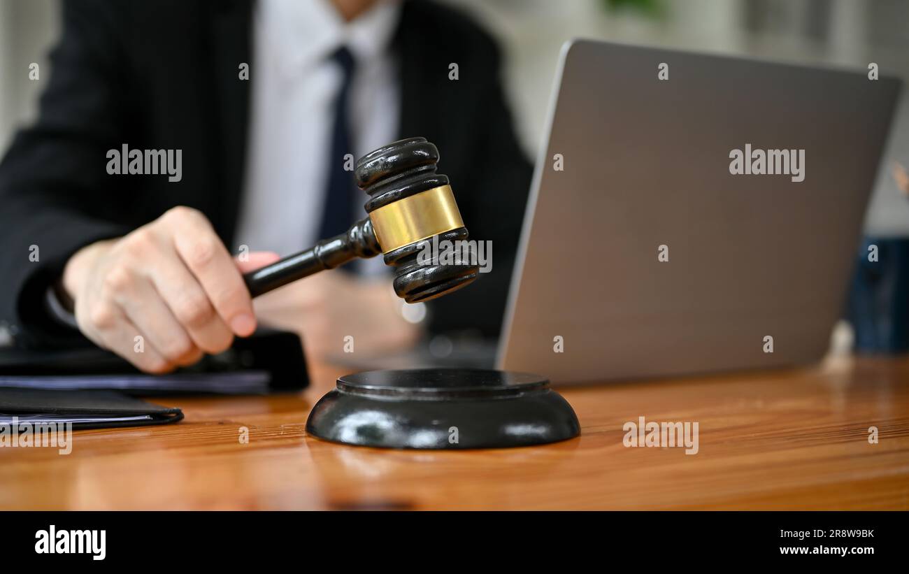 Close-up image of a professional male lawyer holding a judge gavel at ...