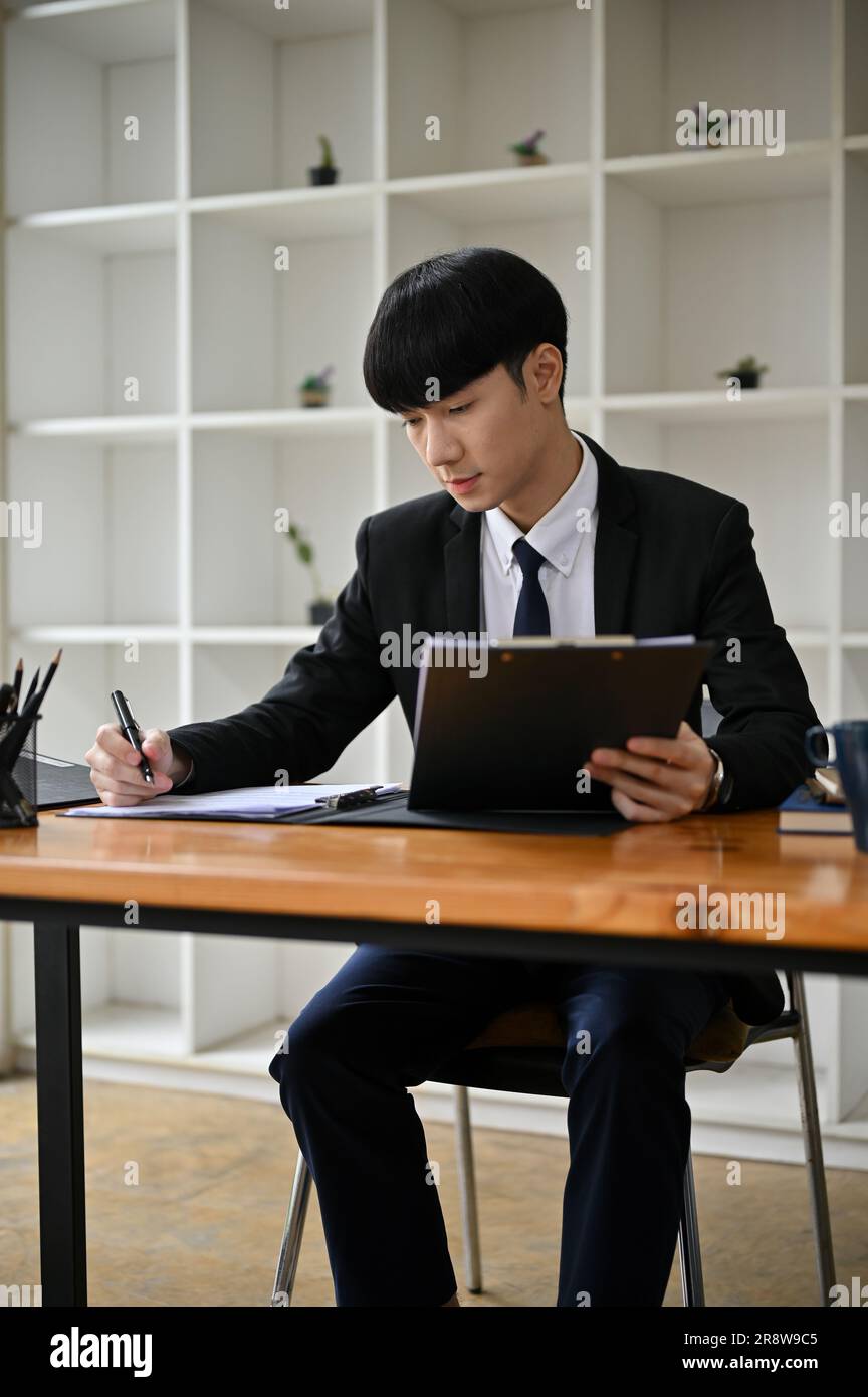 A portrait of a handsome and professional millennial Asian male lawyer ...