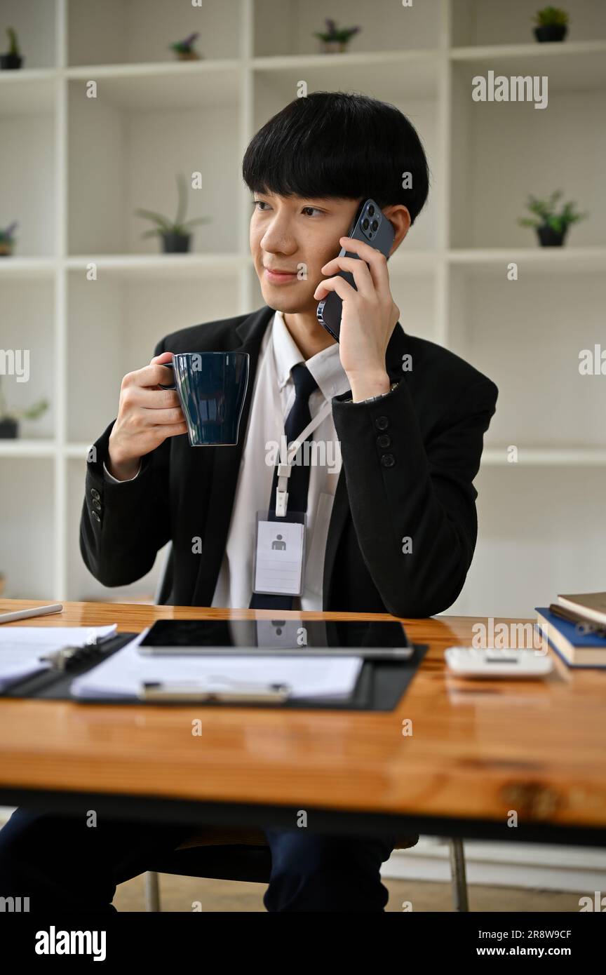 A professional and smart young Asian businessman or male banker in a ...