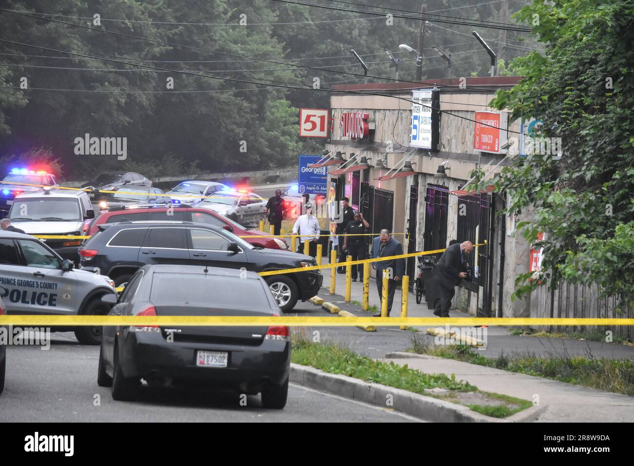 Police officers and crime scene investigators search for evidence and ...