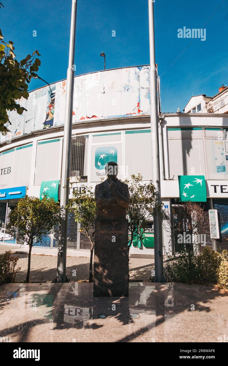 a bronze statue of U.S. Senator Bob Dole in Pristina, Kosovo. A flag ...