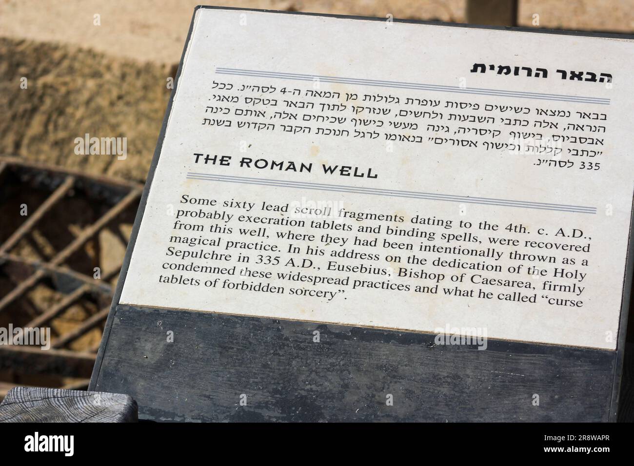 A sign with information about the Roman well at Caesarea National Park ...