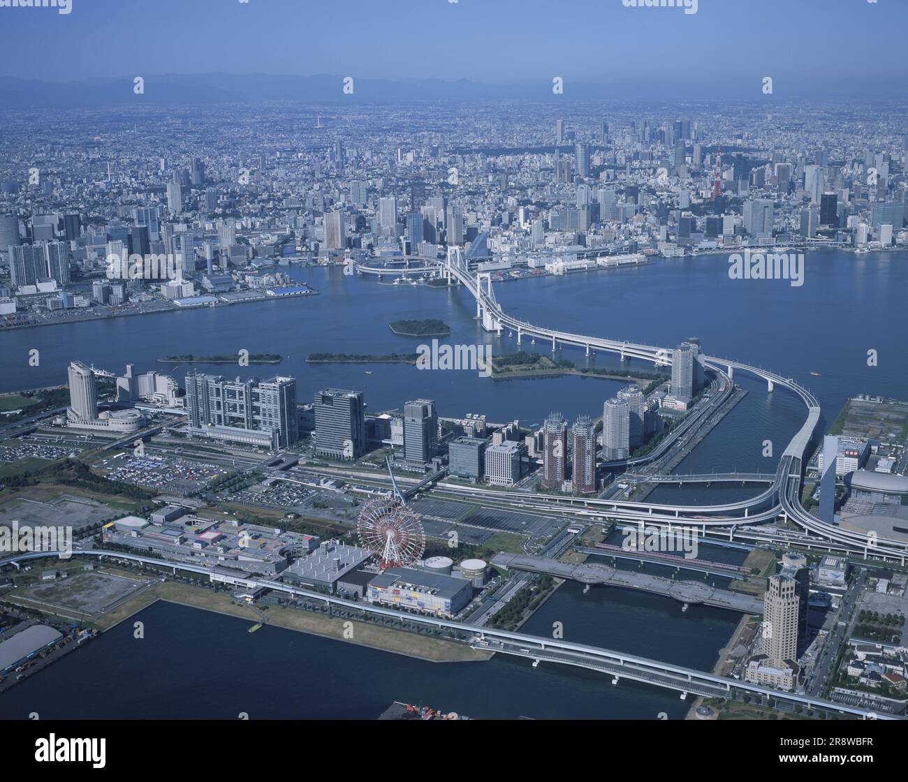 Rinkai Fukutoshin and Rainbow Bridge Stock Photo - Alamy
