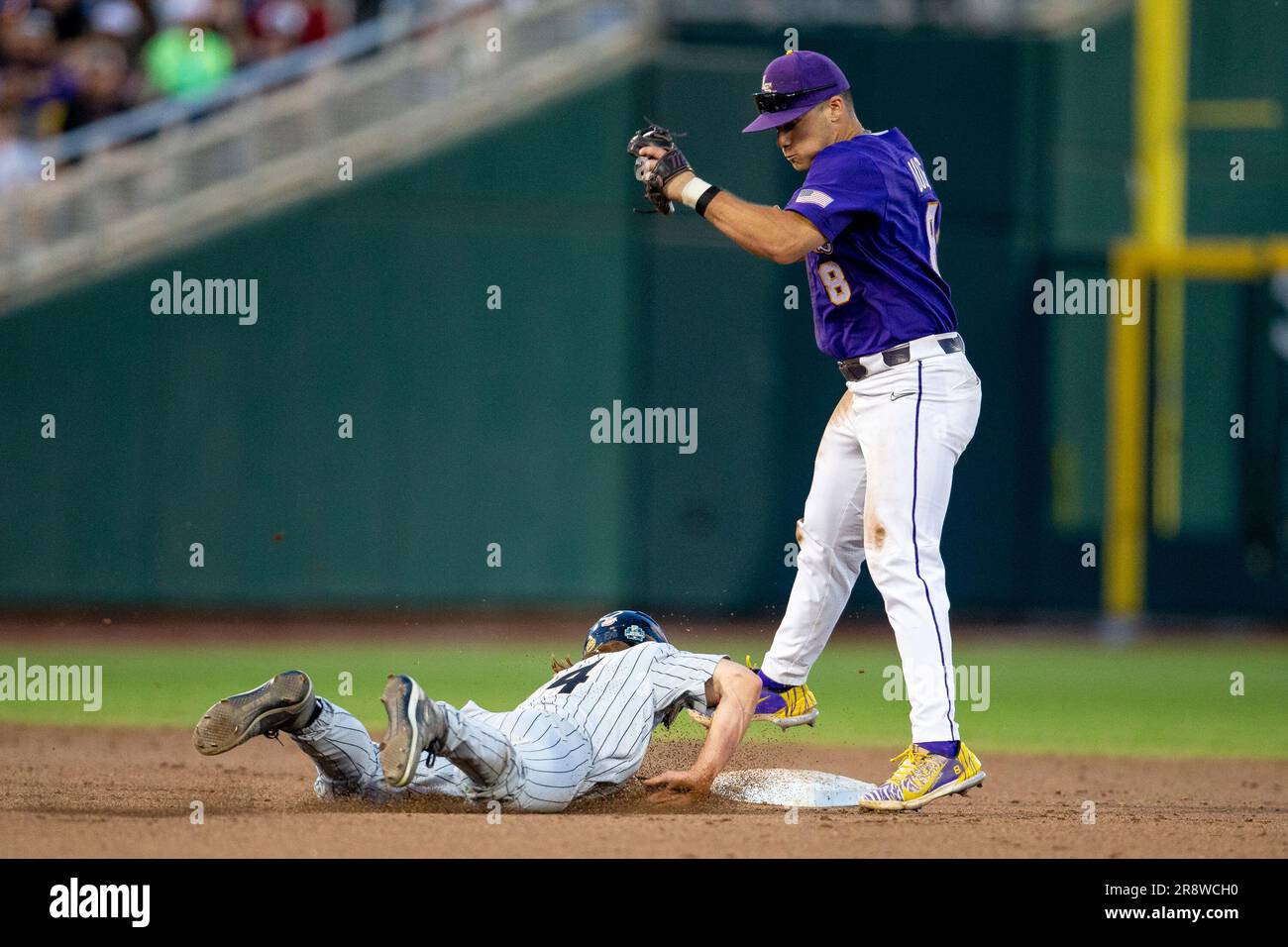 Wake Forest's Tommy Hawke (24) slides safely into second next to LSU's ...