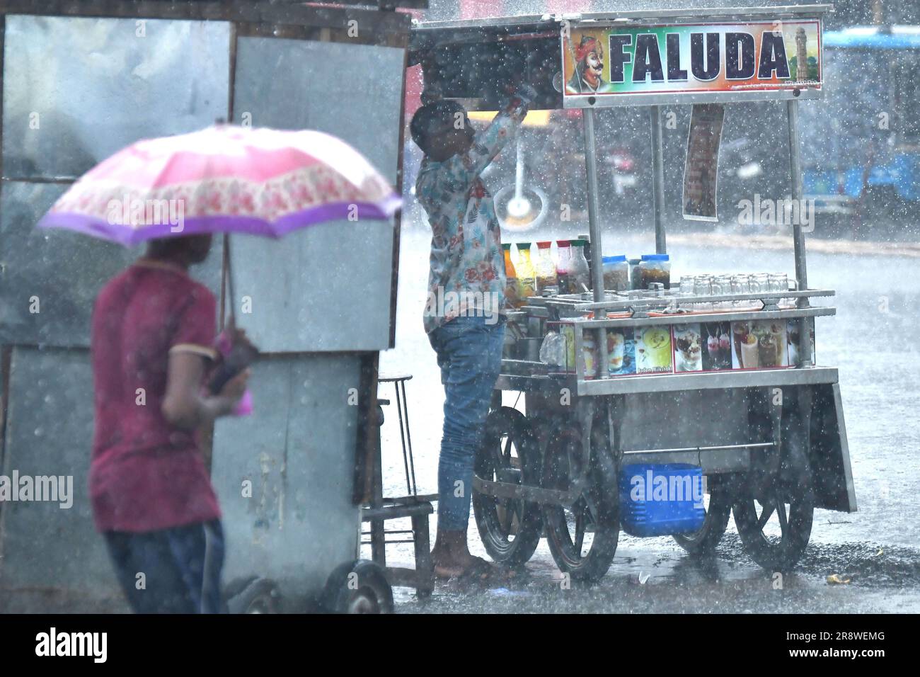 Shop keepers arranging their shop during heavy rains in Agartala ...