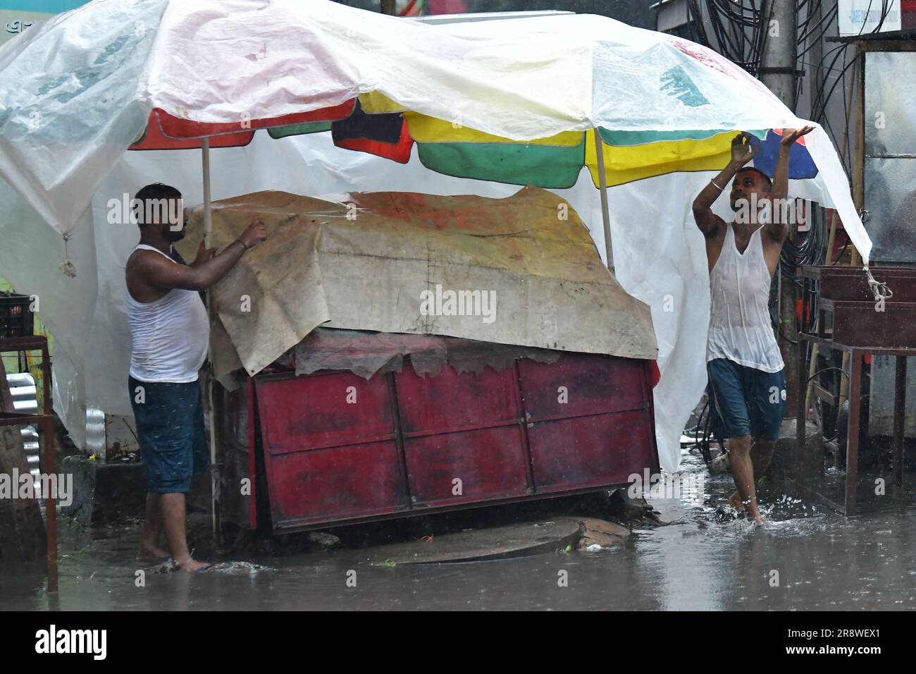Shop keepers arranging their shop during heavy rains in Agartala ...