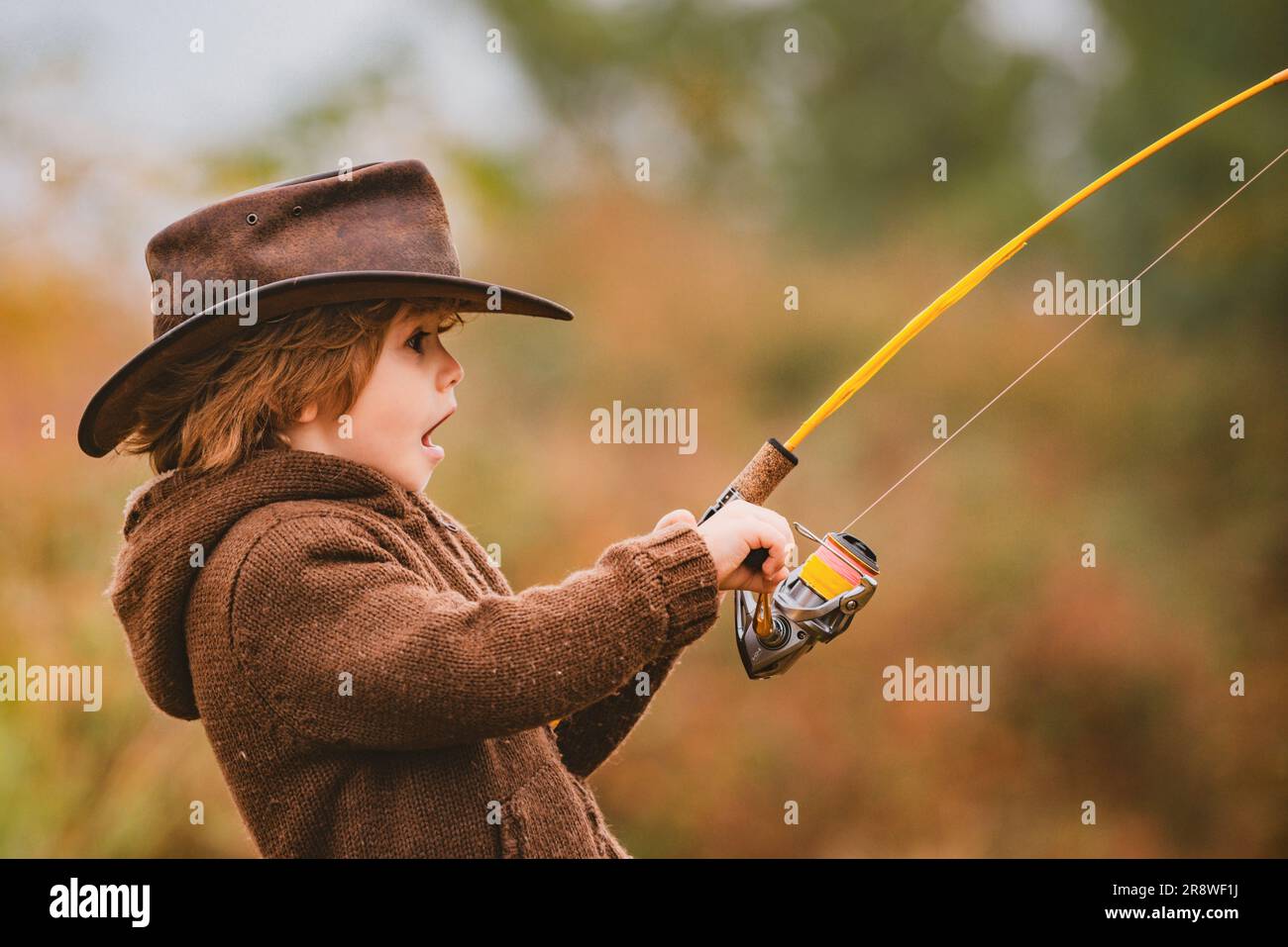 Excited child boy fishing with spinning reel. American children and ...