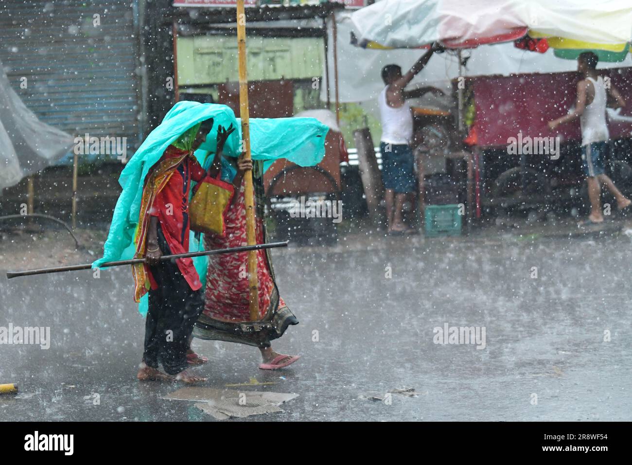 Commuters Make Their Way On A Waterlogged Street During Heavy Rains In Agartala Tripura India