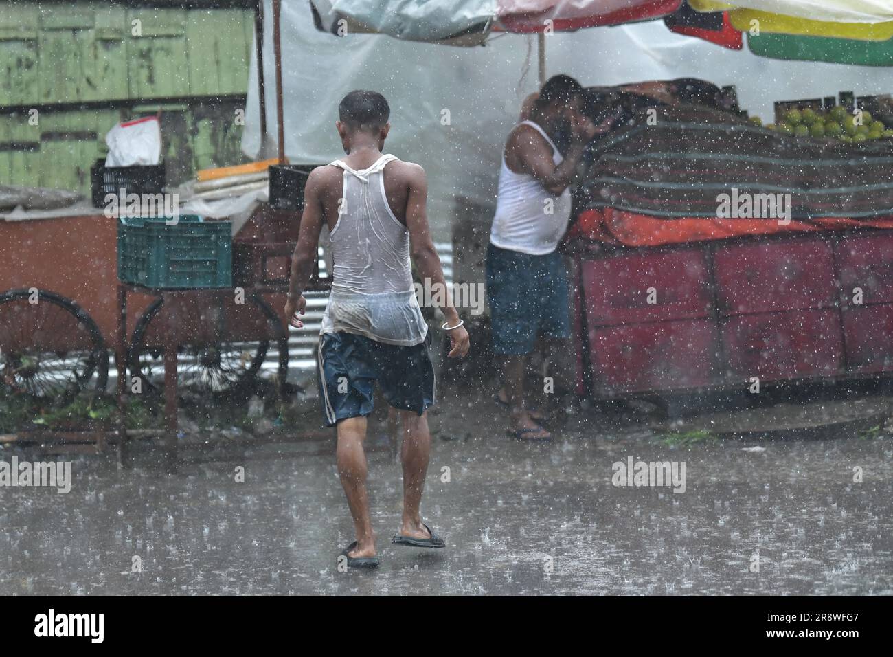 Shop keepers arranging their shop during heavy rains in Agartala ...