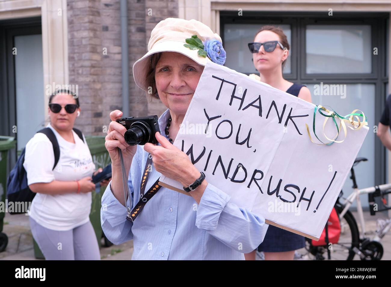 Brixton, UK. A woman holds a sign 'Thank You Windrush', during a parade ...