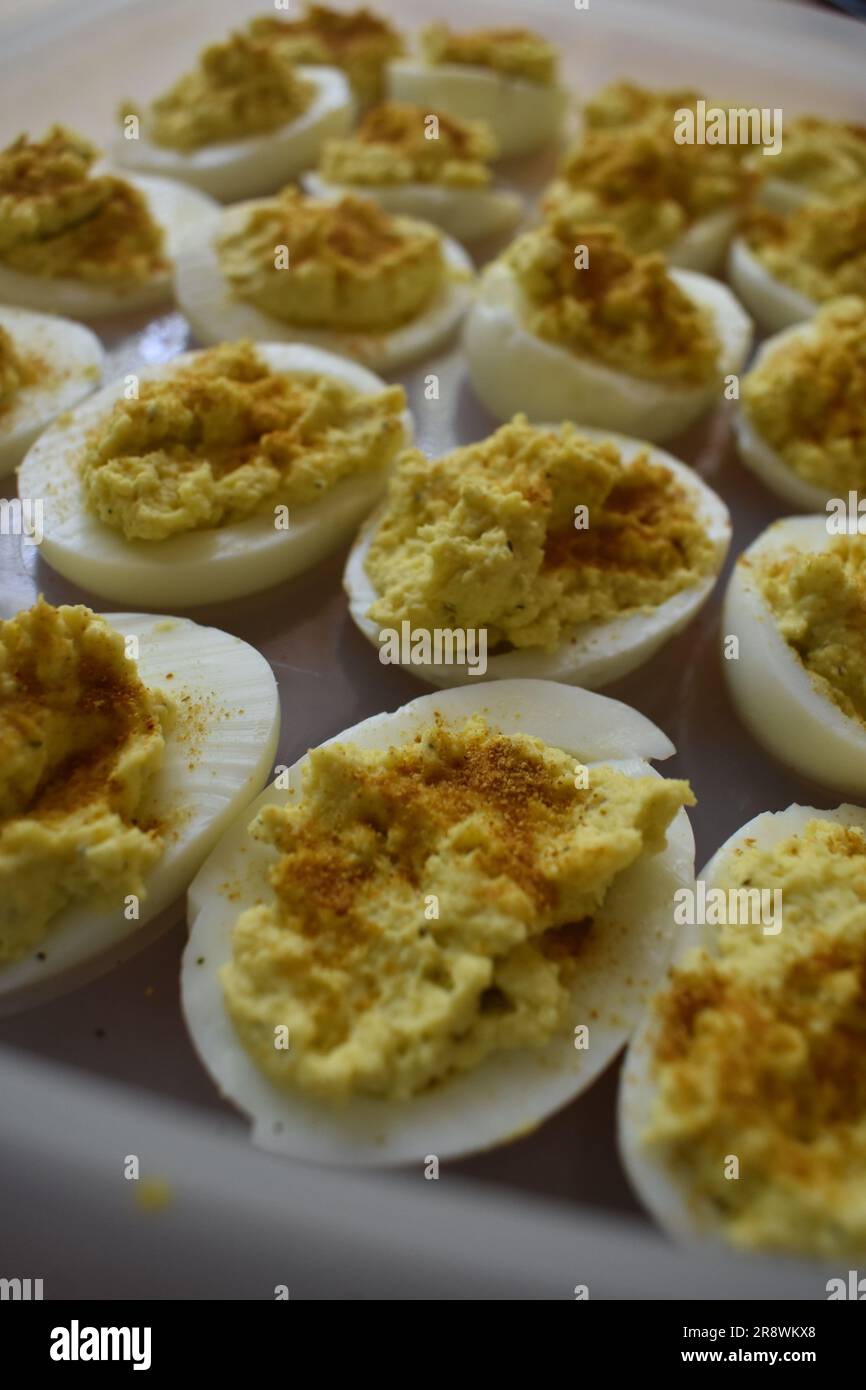A container full of deviled eggs, ready to enjoy with a BBQ or other ...