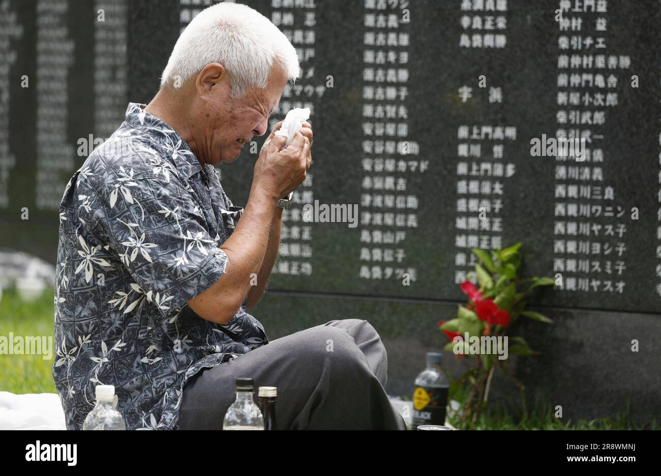 A man cries in front of the Cornerstone of Peace monument walls on ...