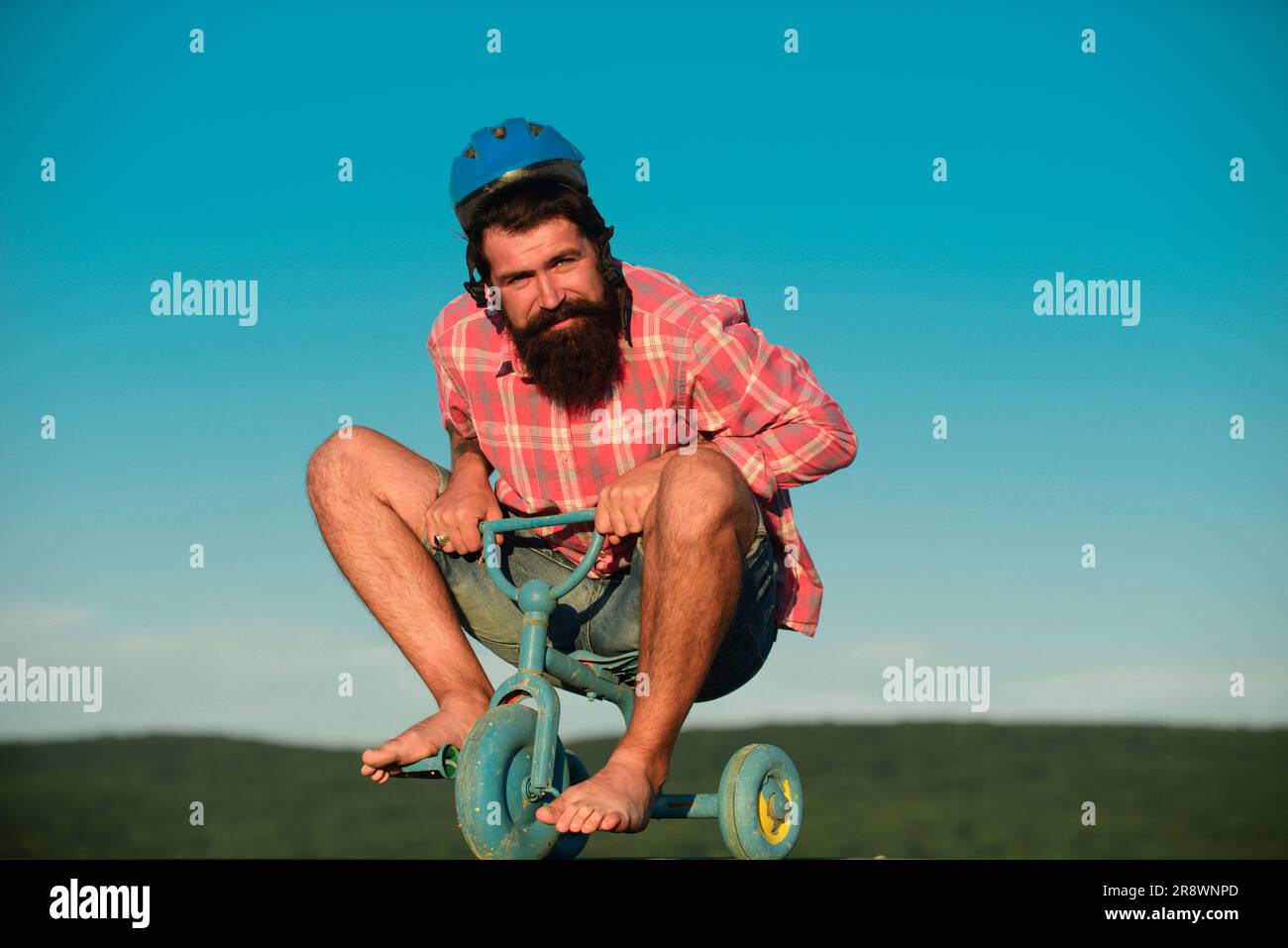 Crazy Young man riding three wheeled bicycle Stock Photo - Alamy