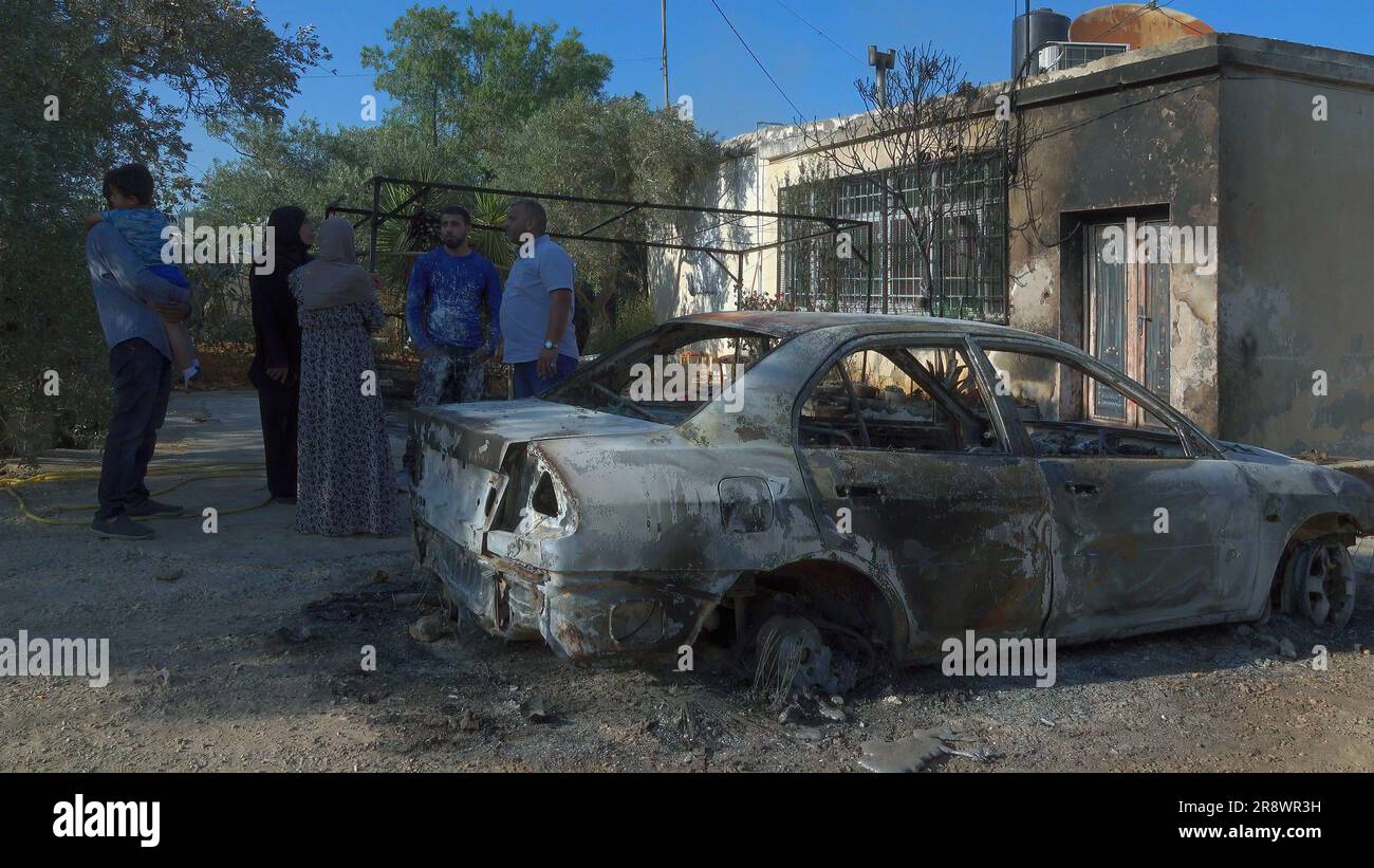 TURMUS AYYA, ISRAEL - JUNE 21: Palestinians stand by a car and a house ...