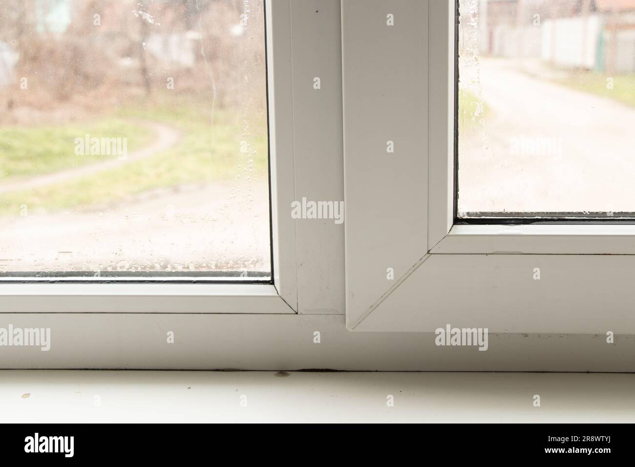 metal-plastic window in an apartment damaged by mold and moisture close ...