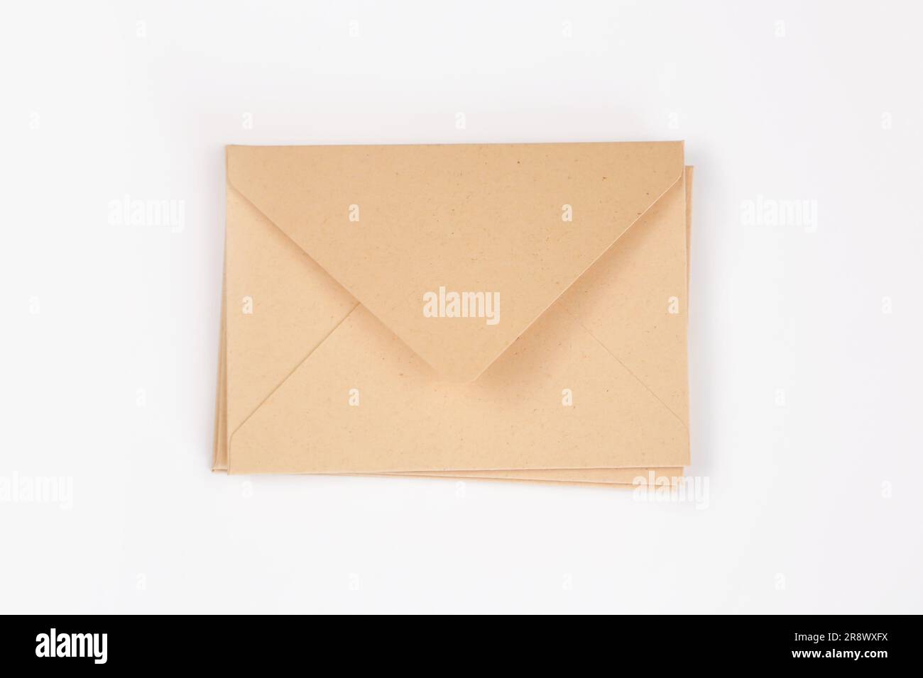 Stack of light brown paper open envelope on white isolated background ...
