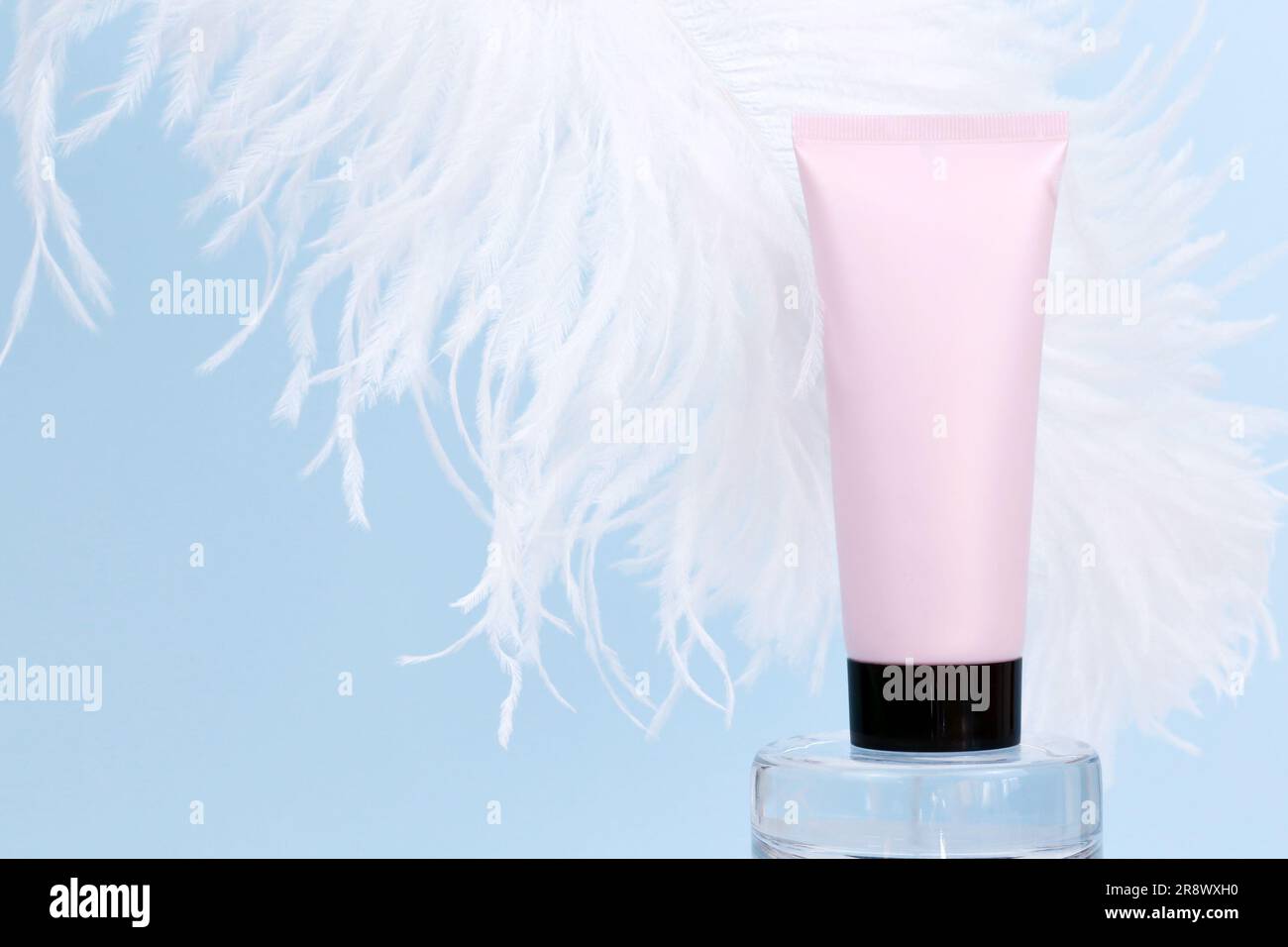 Pink squeeze bottle cream tube with black screw cap and large white ...