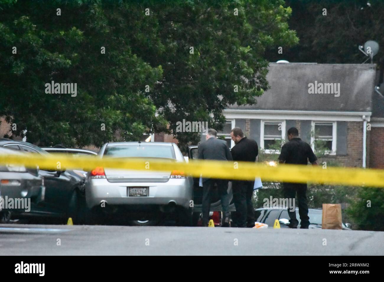 Investigators at the crime scene along with evidence markers. Police ...