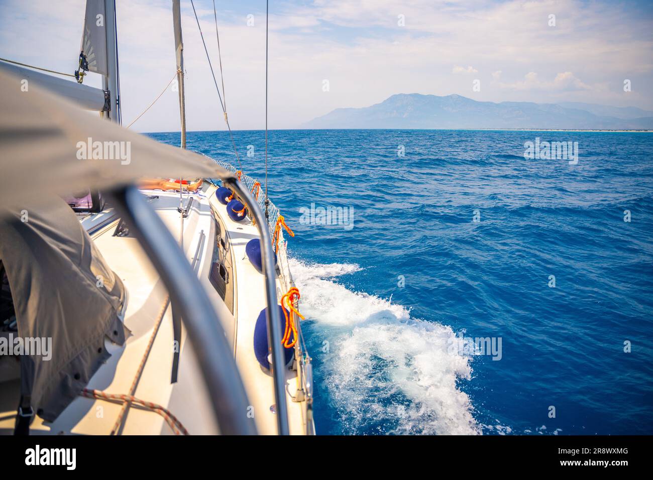 Yacht sailing in an open sea. Close-up view of side of the boat. Clear ...