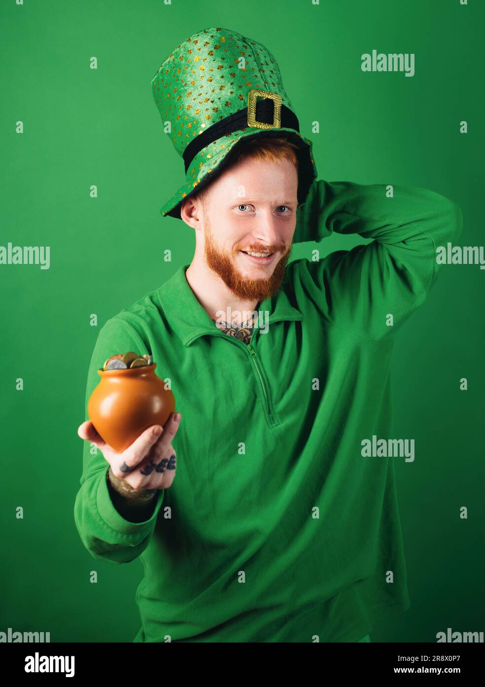 Happy St Patricks Day concept with pot of gold. Lucky charms on green ...