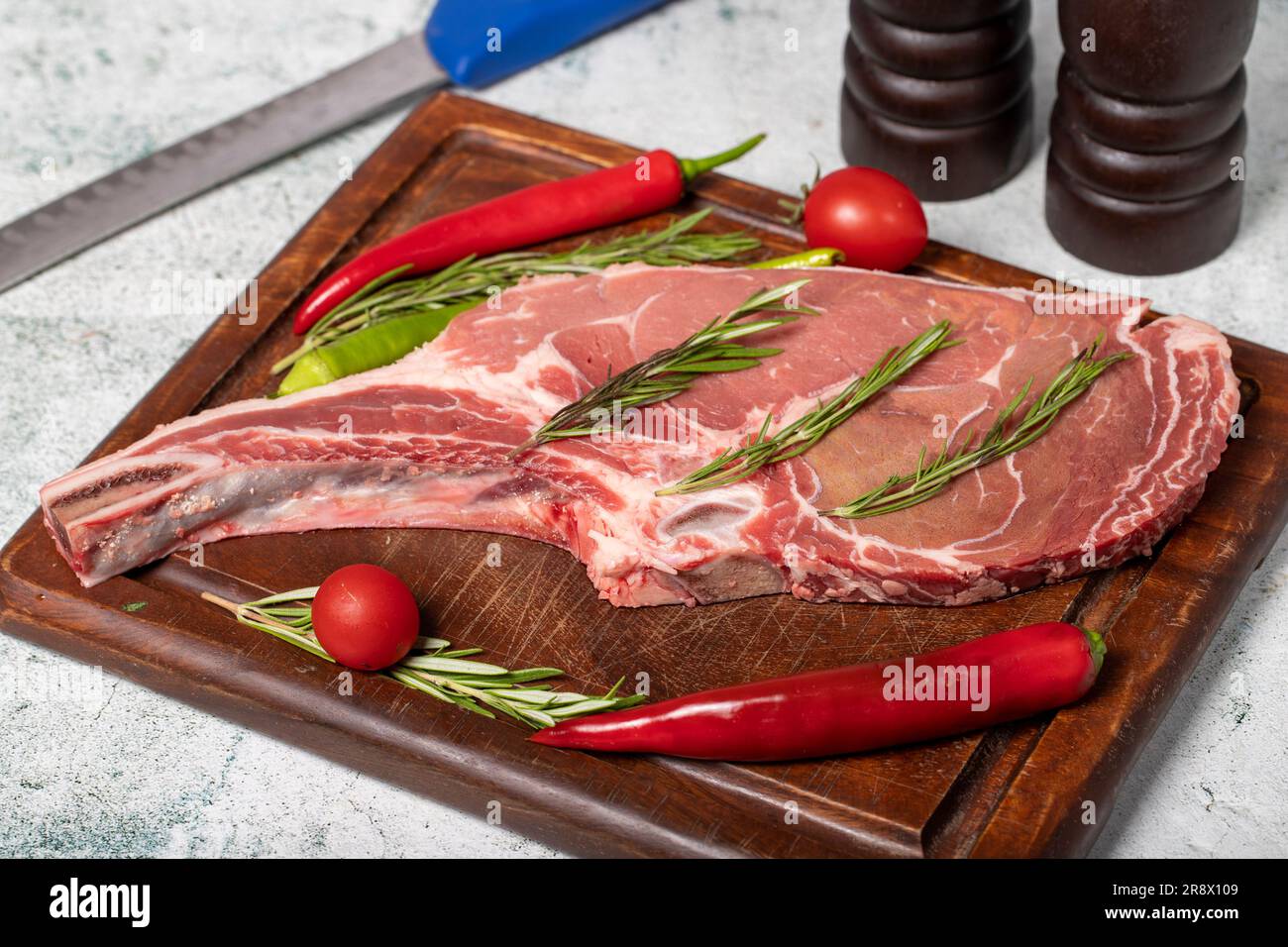 Raw veal chops. Fresh veal rib boned raw chops on wood serving board ...