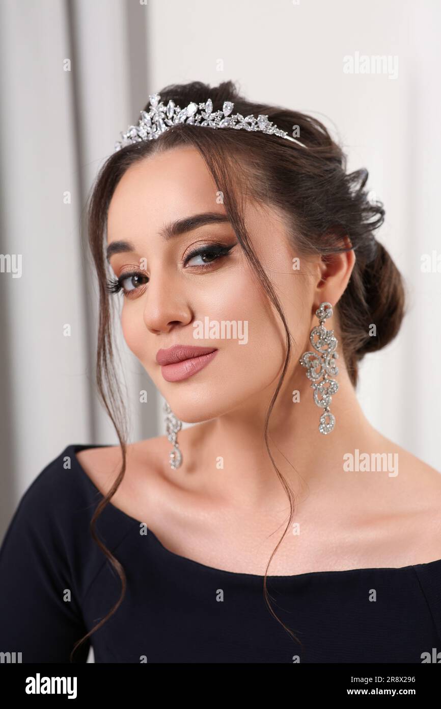 Beautiful young woman wearing luxurious tiara indoors Stock Photo - Alamy