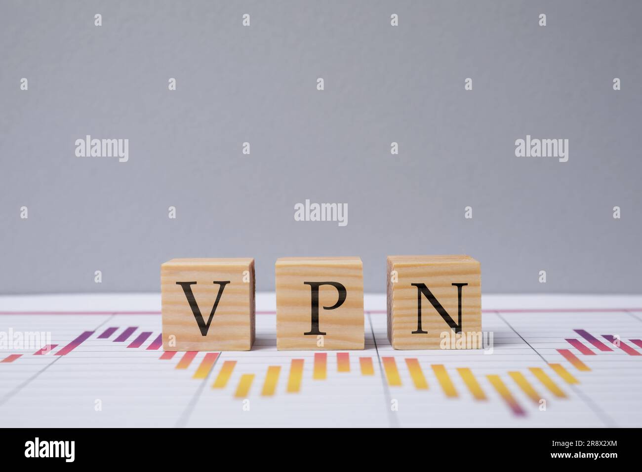 Cubes with acronym VPN on table against light grey background, space ...