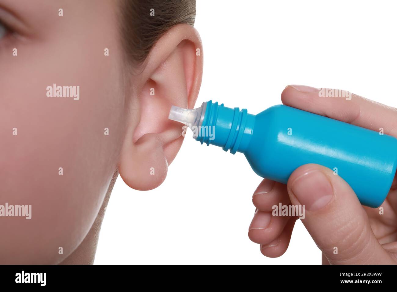 Mother dripping medication into daughter's ear on white background ...