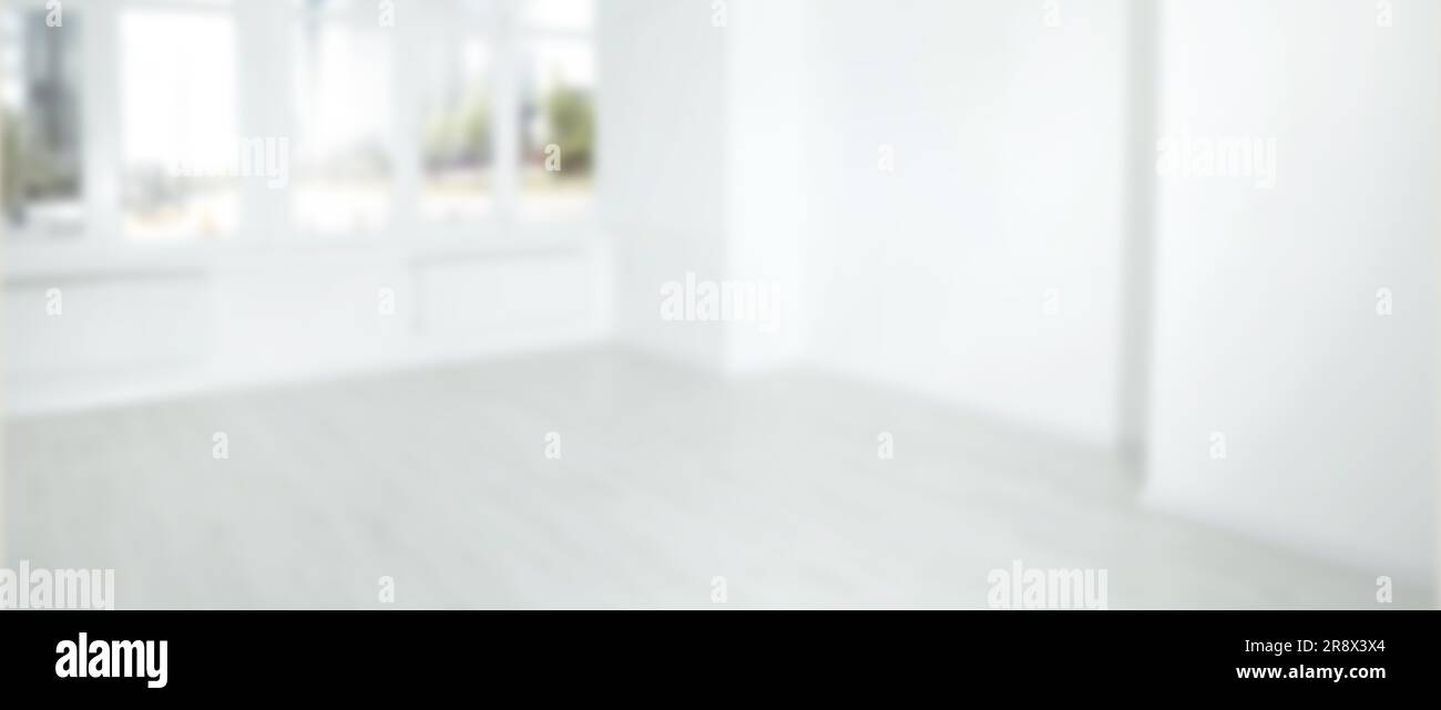 Empty room with white wall and large window, blurred view. Banner ...