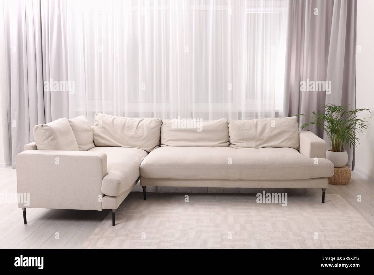 Comfortable sofa and window with beautiful curtains in room. Interior ...