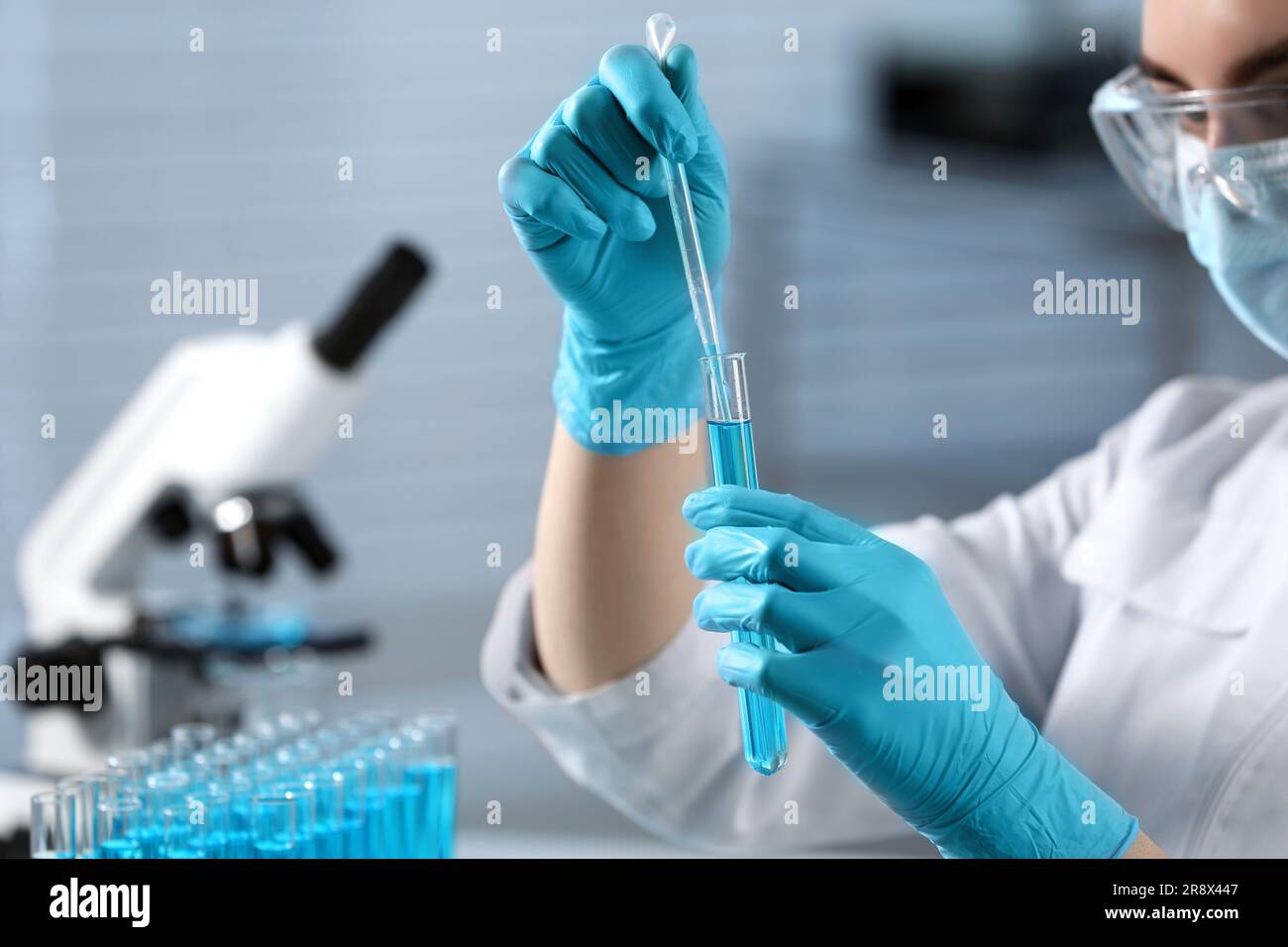 Scientist dropper taking liquid sample hi-res stock photography and ...