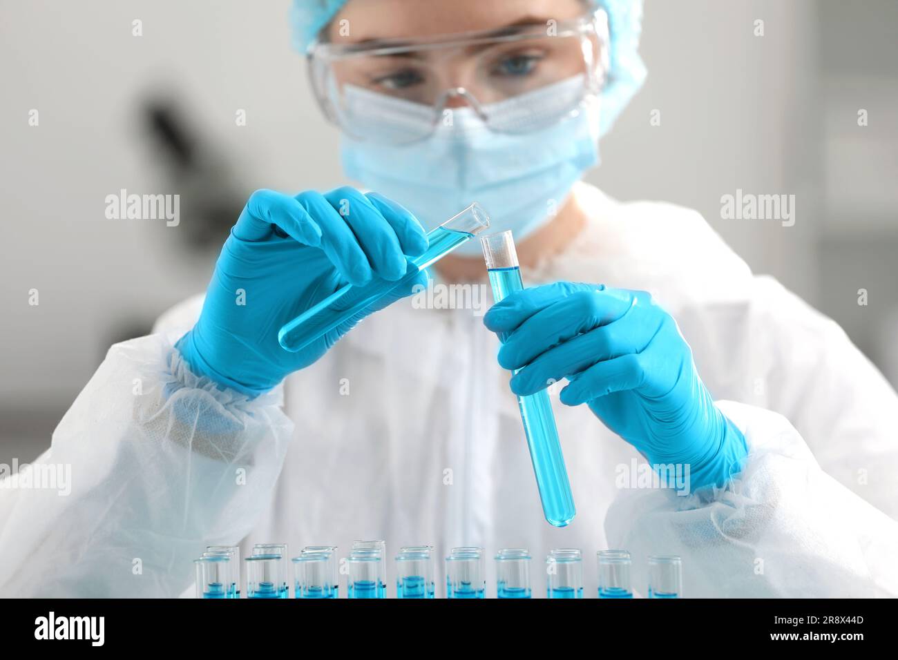 Scientist pouring sample into test tube in laboratory Stock Photo - Alamy