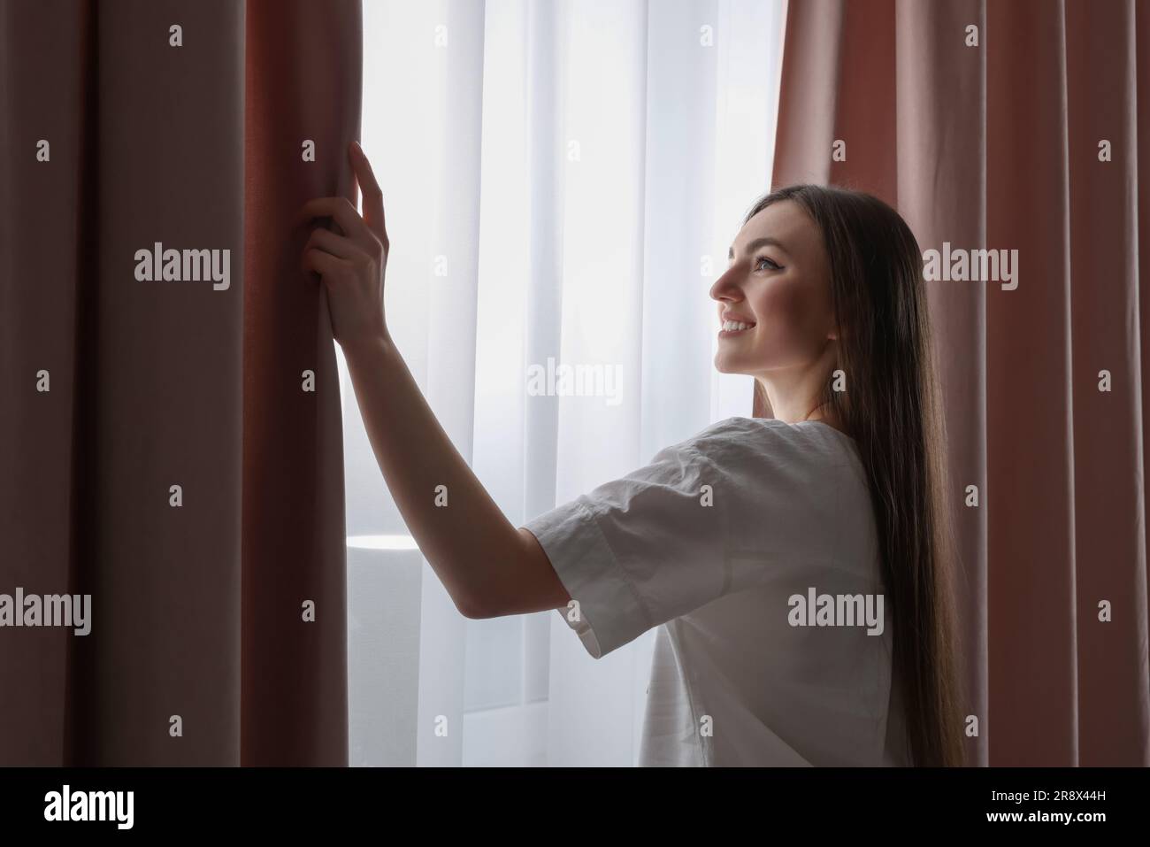 Woman opening stylish curtains hi-res stock photography and images - Alamy