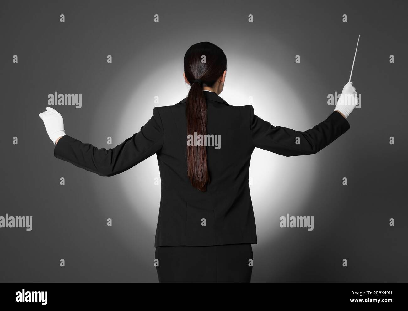 Professional conductor with baton on grey background, back view Stock ...