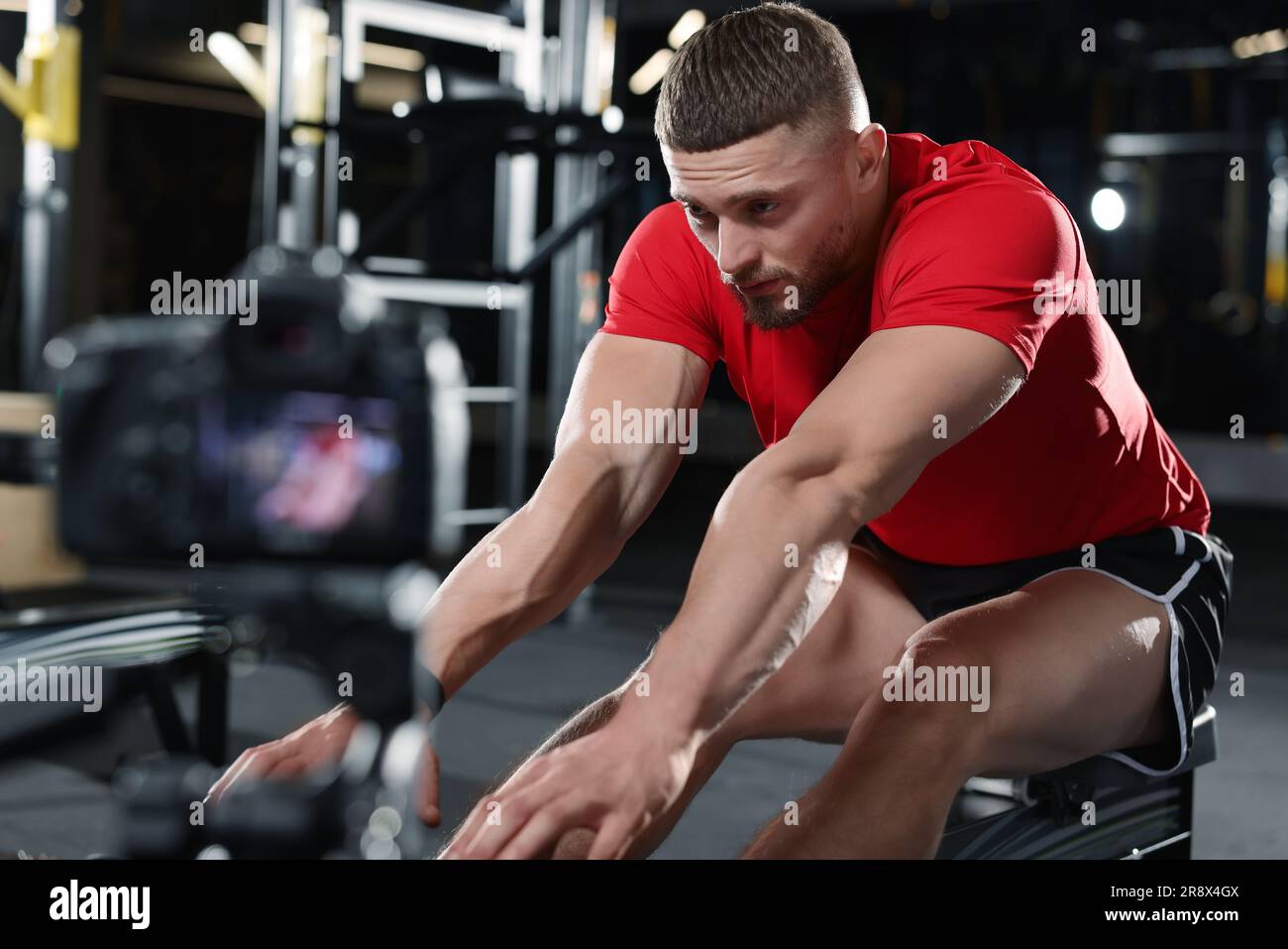 Man recording workout on camera at gym. Online fitness trainer Stock ...