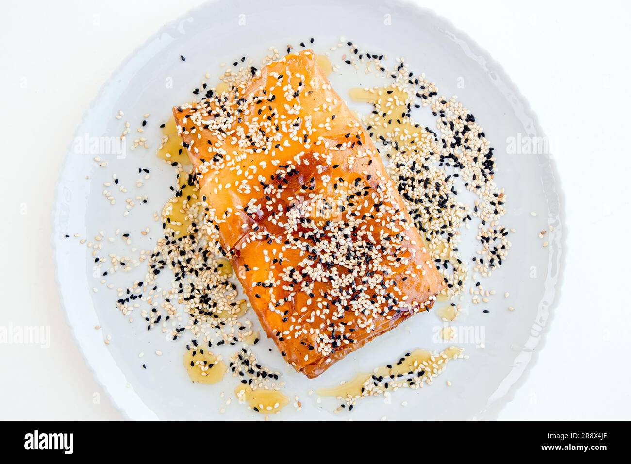 Feta cheese wrapped in crispy phyllo with sweet honey sauce and sesame ...